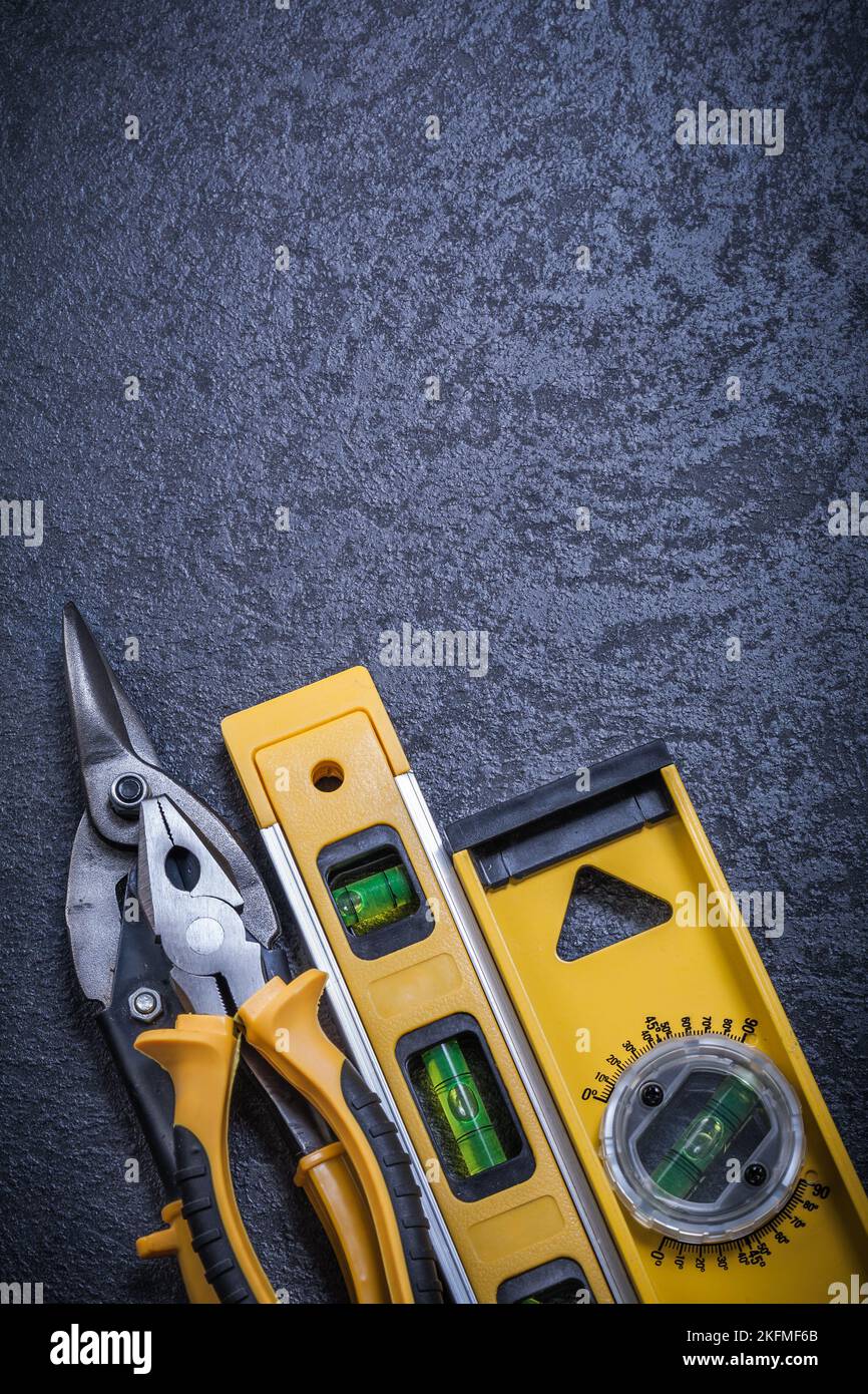 Steel cutter gripping tongs construction level on black background ...