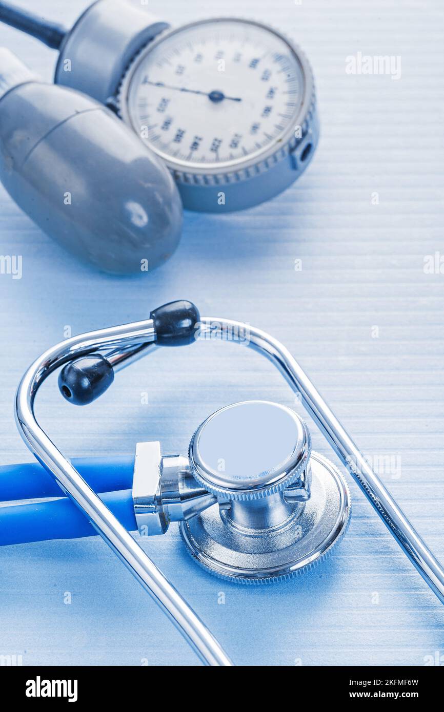 stethoscope and blood pressure monitor on blue background medical ...