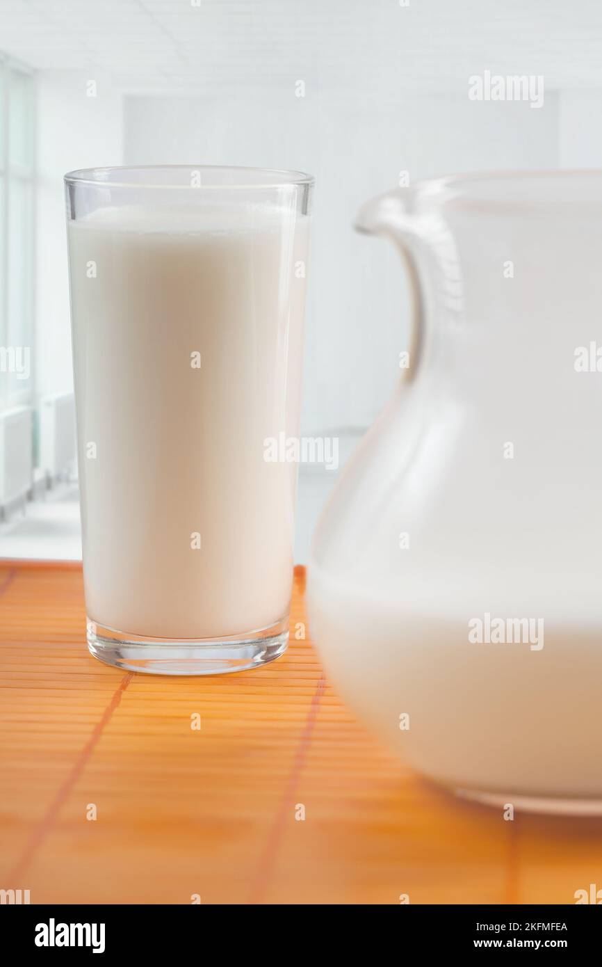 The jug and glass with milk stand on a table Stock Photo - Alamy