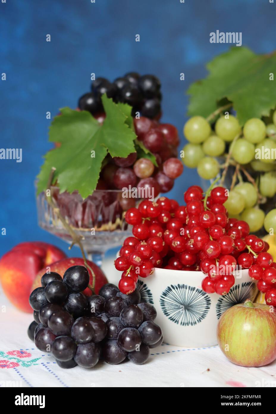 Colorful still life with seasonal fruit and berries on textured ...