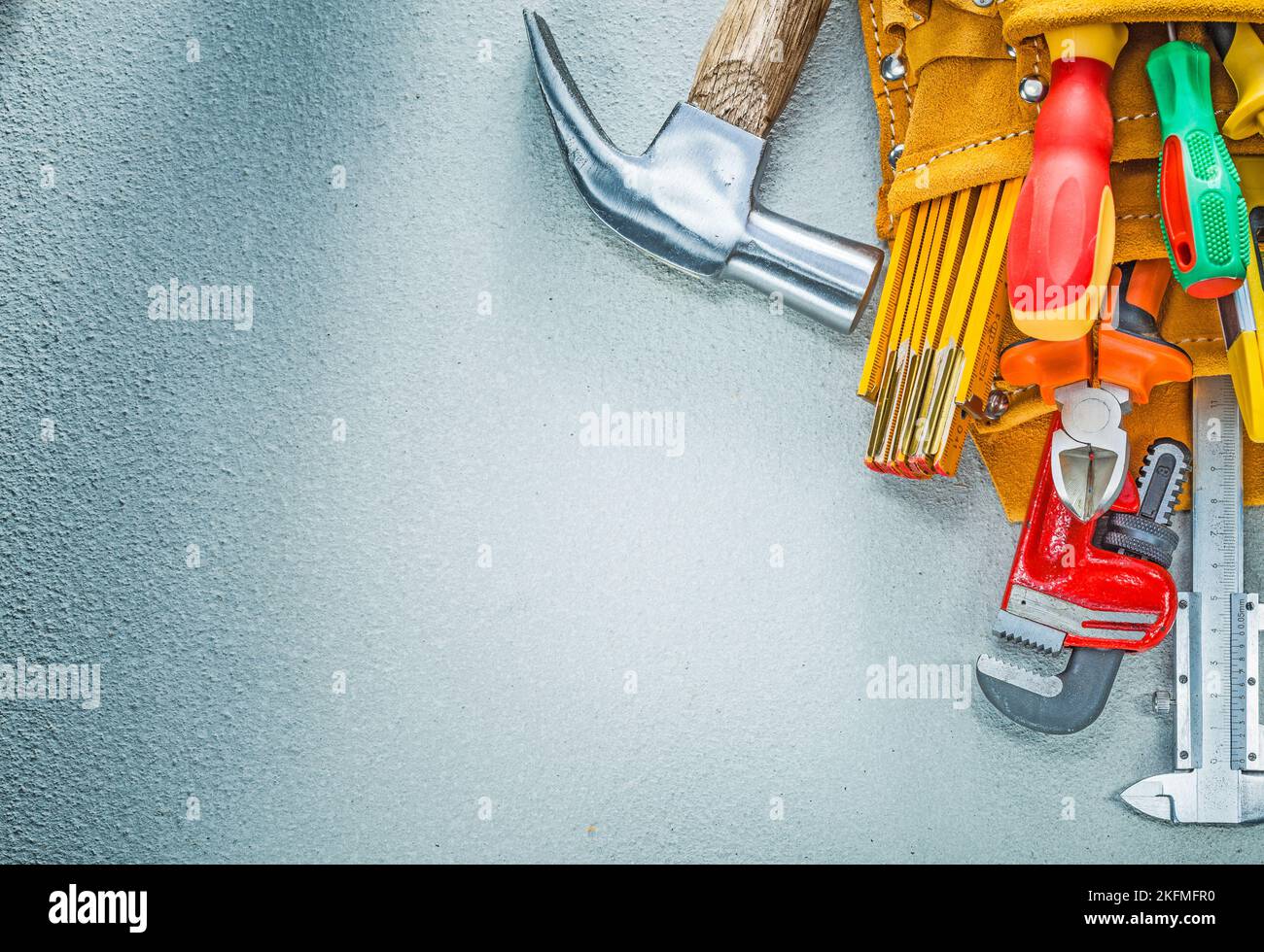 Toolbelt construction tooling on concrete background Stock Photo - Alamy