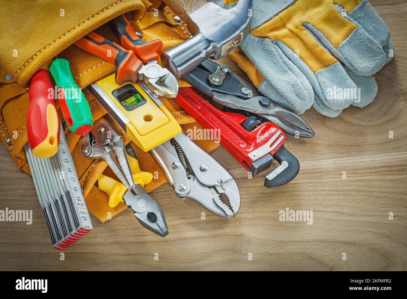Tools in leather building belt on wooden board top view Stock Photo - Alamy