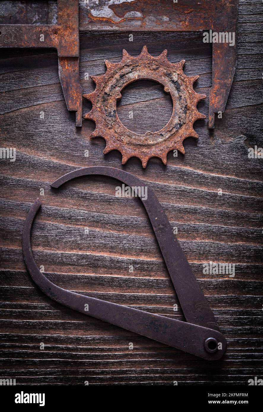 Top view of rusty longstanding measuring calipers with gear wheel on ...