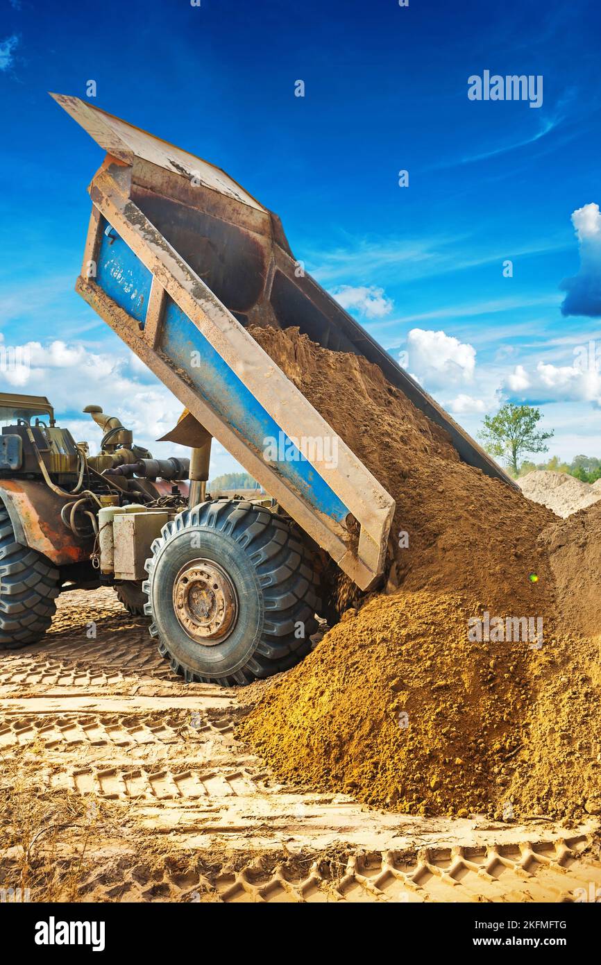tipper unloadding sand from scoop Stock Photo - Alamy