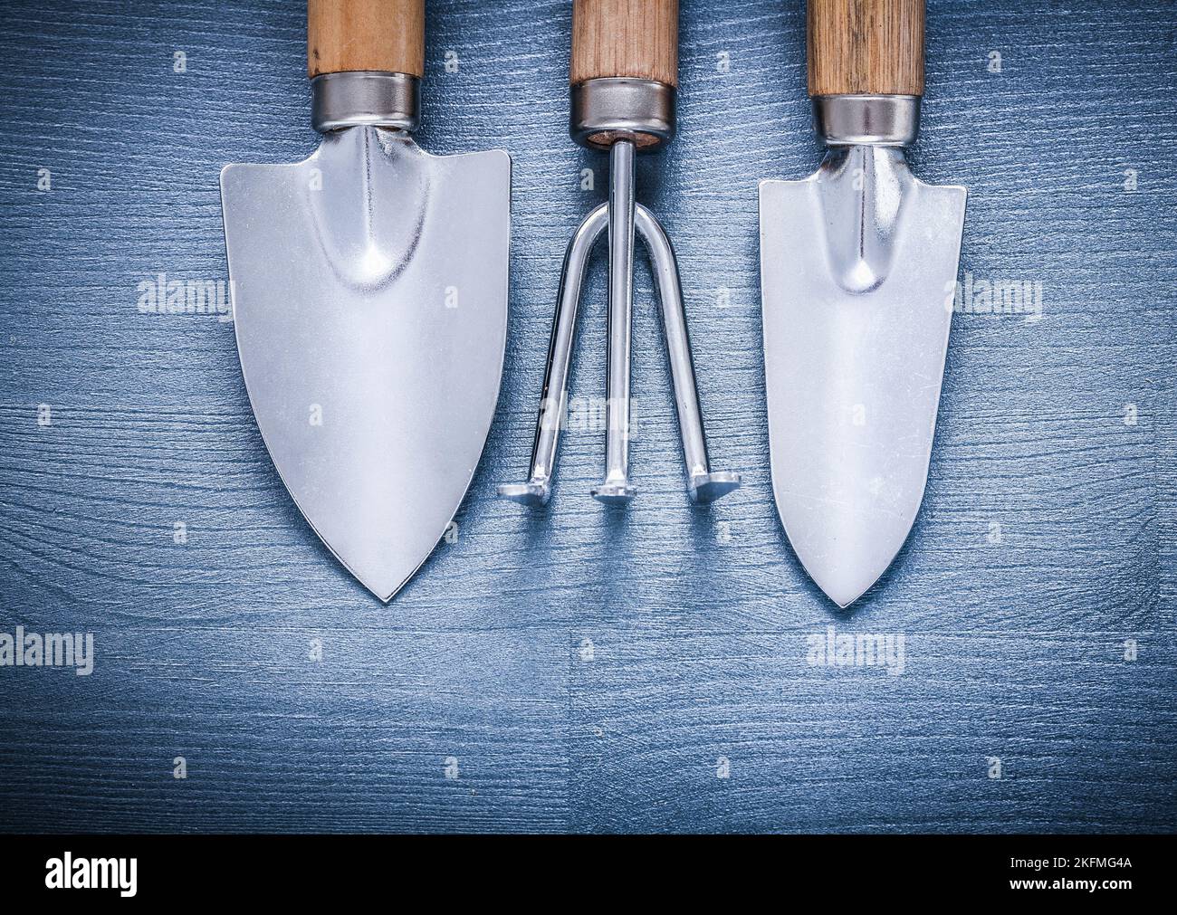 two little garden spades and fork Stock Photo - Alamy