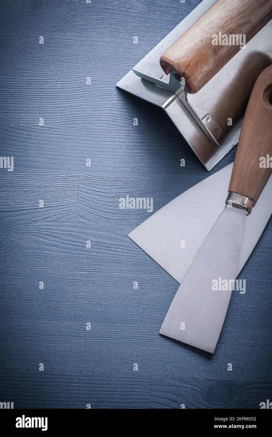 two paint scrapers with wood handles and angle former Stock Photo - Alamy