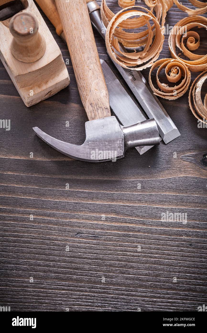 Vertical version of planer claw hammer metal chisels and wooden curled ...