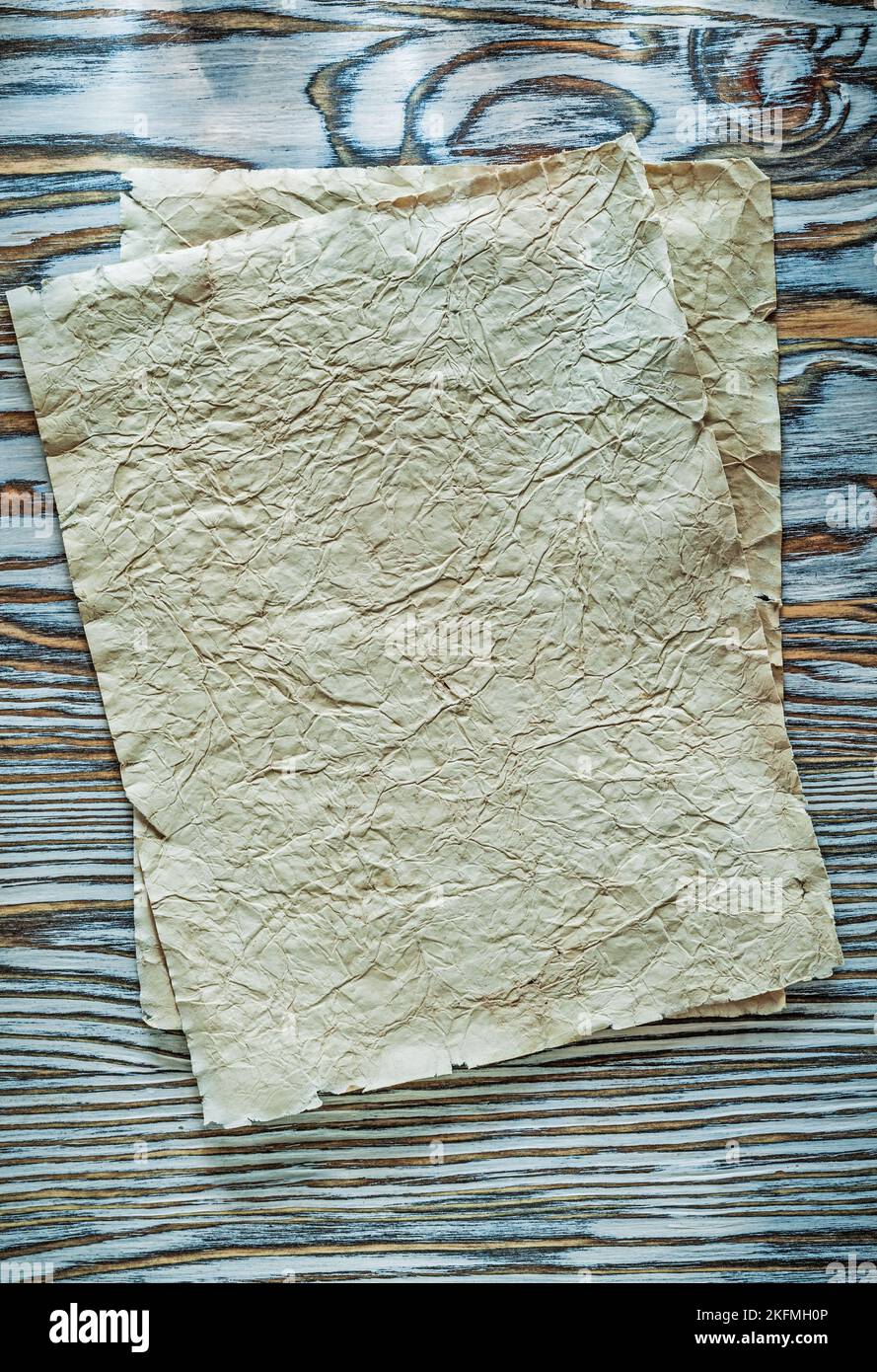 Vintage crumpled paper scroll on wooden board top view Stock Photo - Alamy
