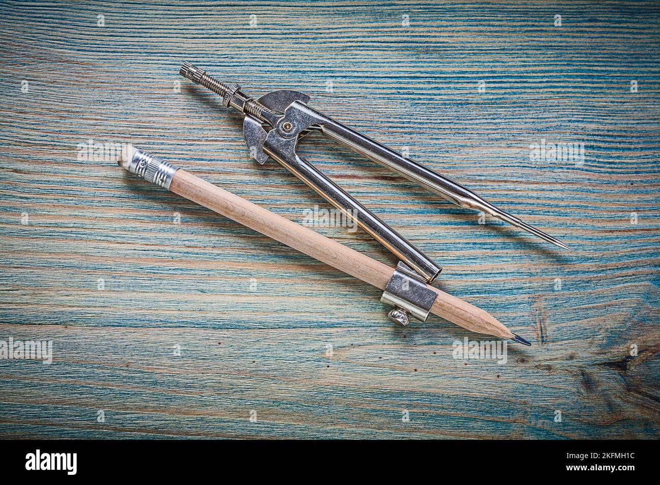 Vintage divider pencil on wooden board construction concept Stock Photo ...