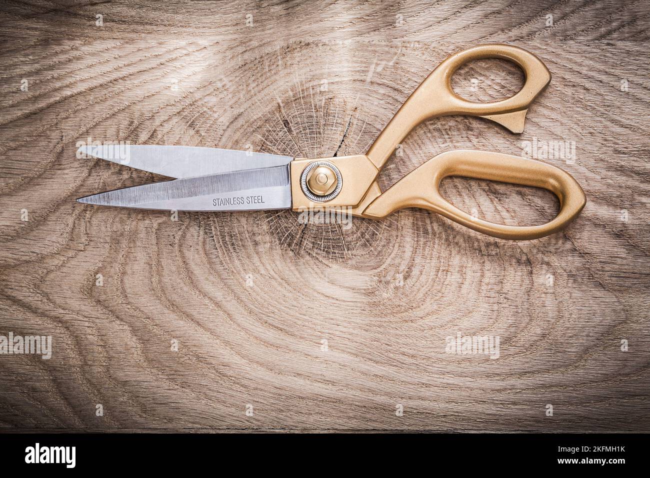Vintage golden scissors on wooden board Stock Photo - Alamy