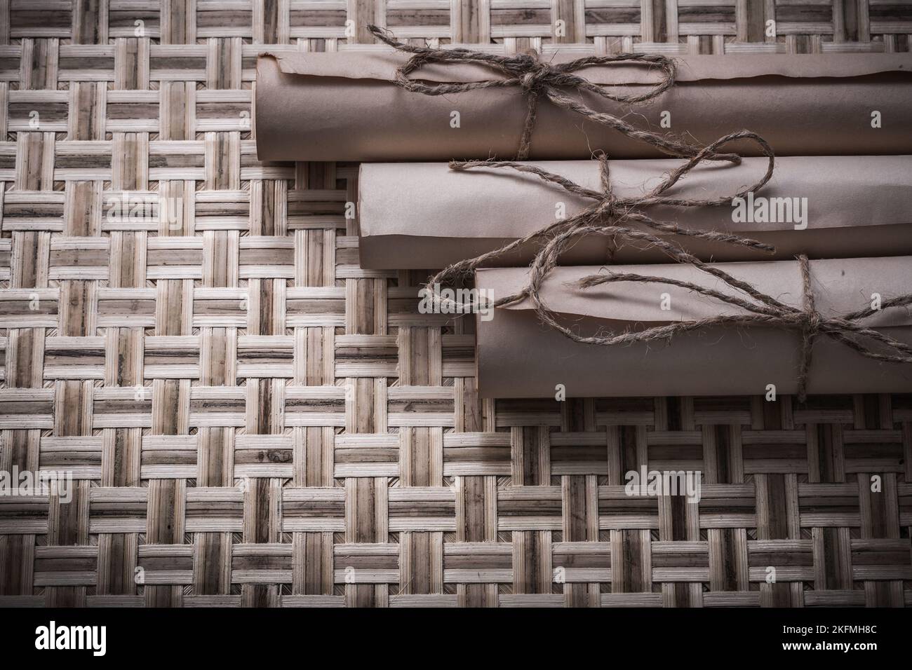 Vintage paper rolls on wicker wooden mat top view Stock Photo - Alamy