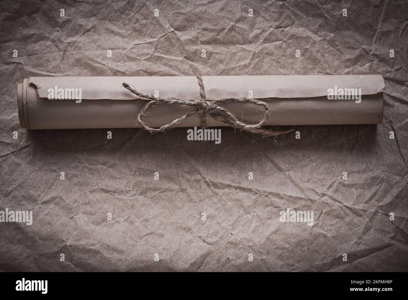 Vintage paper scroll on crumpled wrapping sheet Stock Photo - Alamy