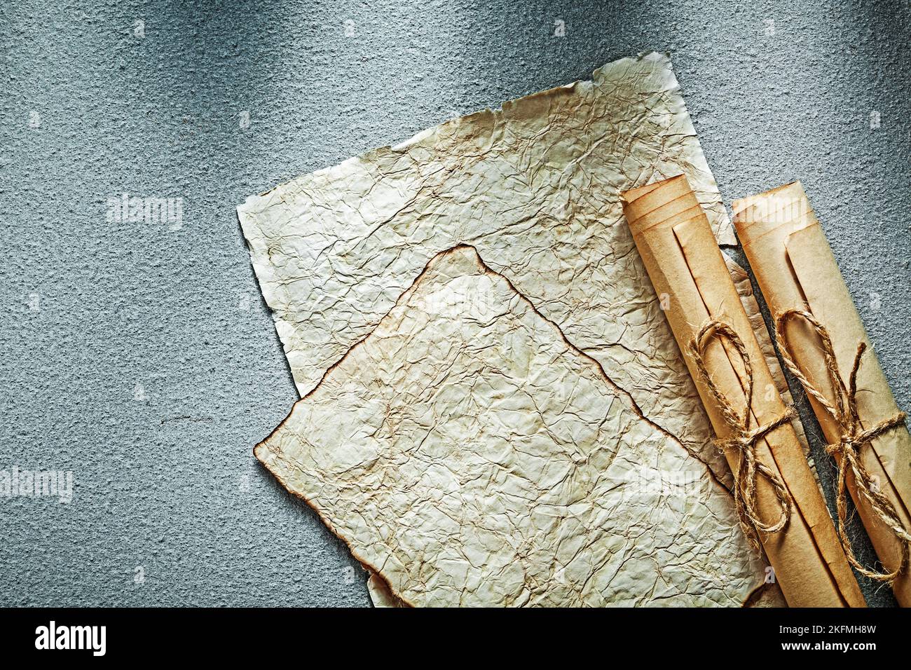Vintage paper rolls on grey background Stock Photo - Alamy