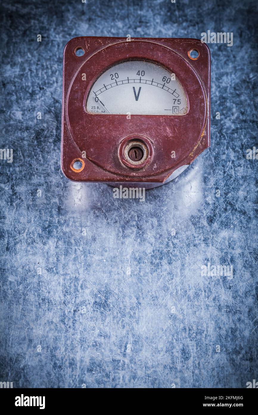 Voltmeter on scratched metallic background vertical view vintage ...