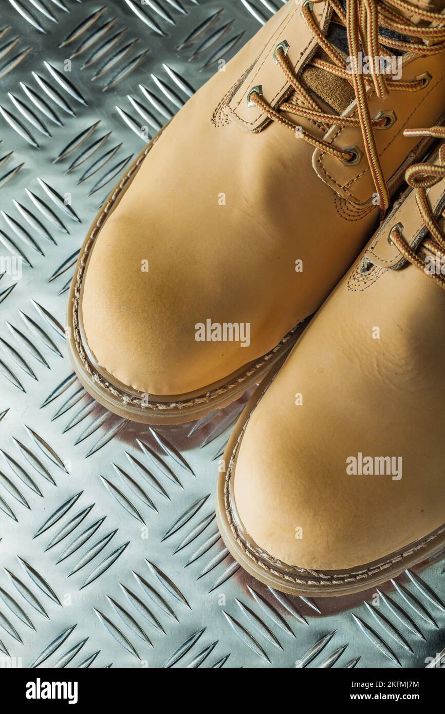 Waterproof safety boots on corrugated metal sheet Stock Photo - Alamy