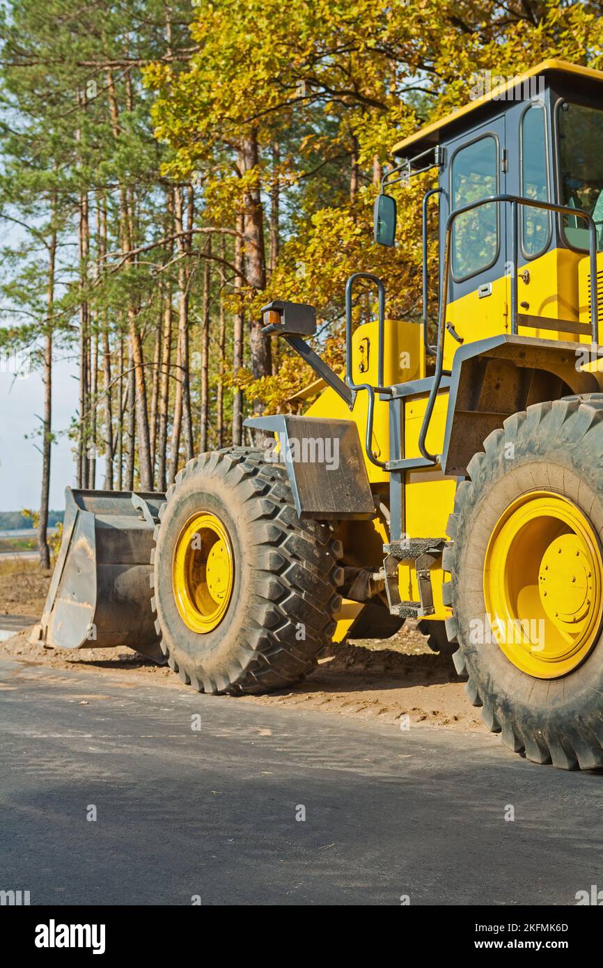 wheelloader in forest near edge of road rear view Stock Photo - Alamy