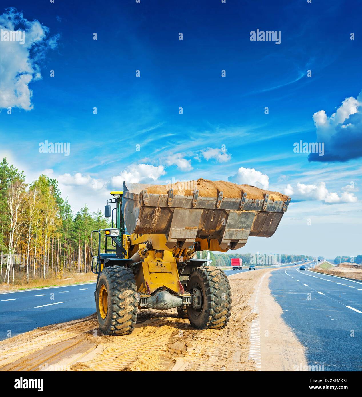 wheelloader with scoop full of sand construction concept Stock Photo ...