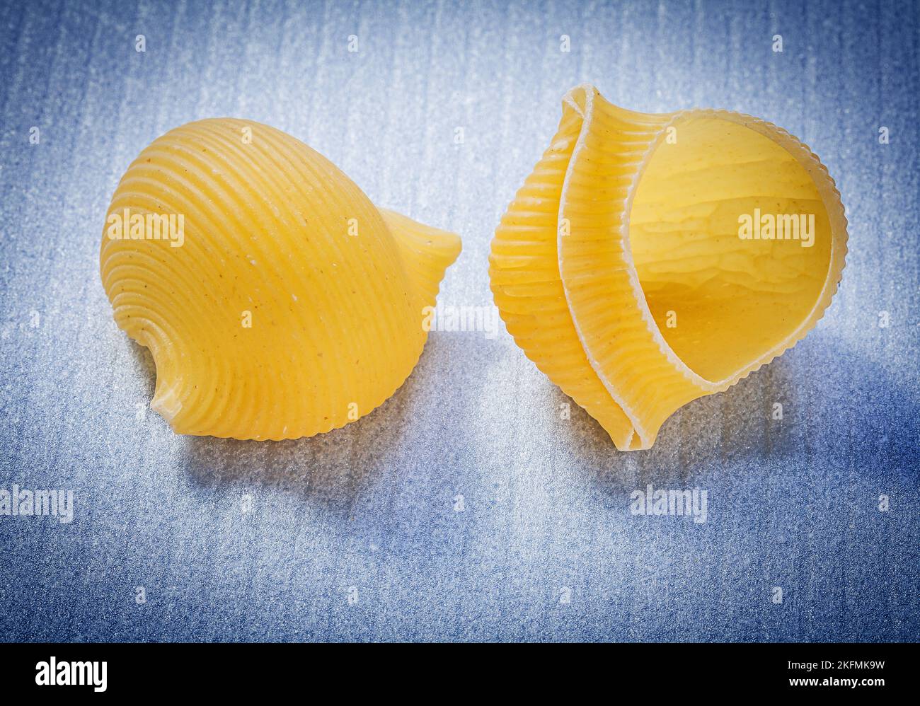 Wholegrain pasta shells on blue background food and drink concept Stock ...