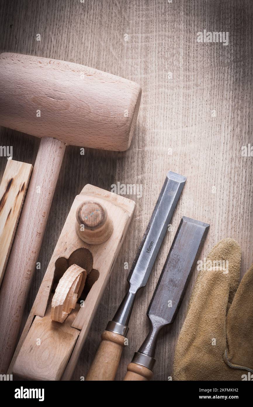 Wooden bricks mallet shaving plane firmer chisels leather gloves on ...