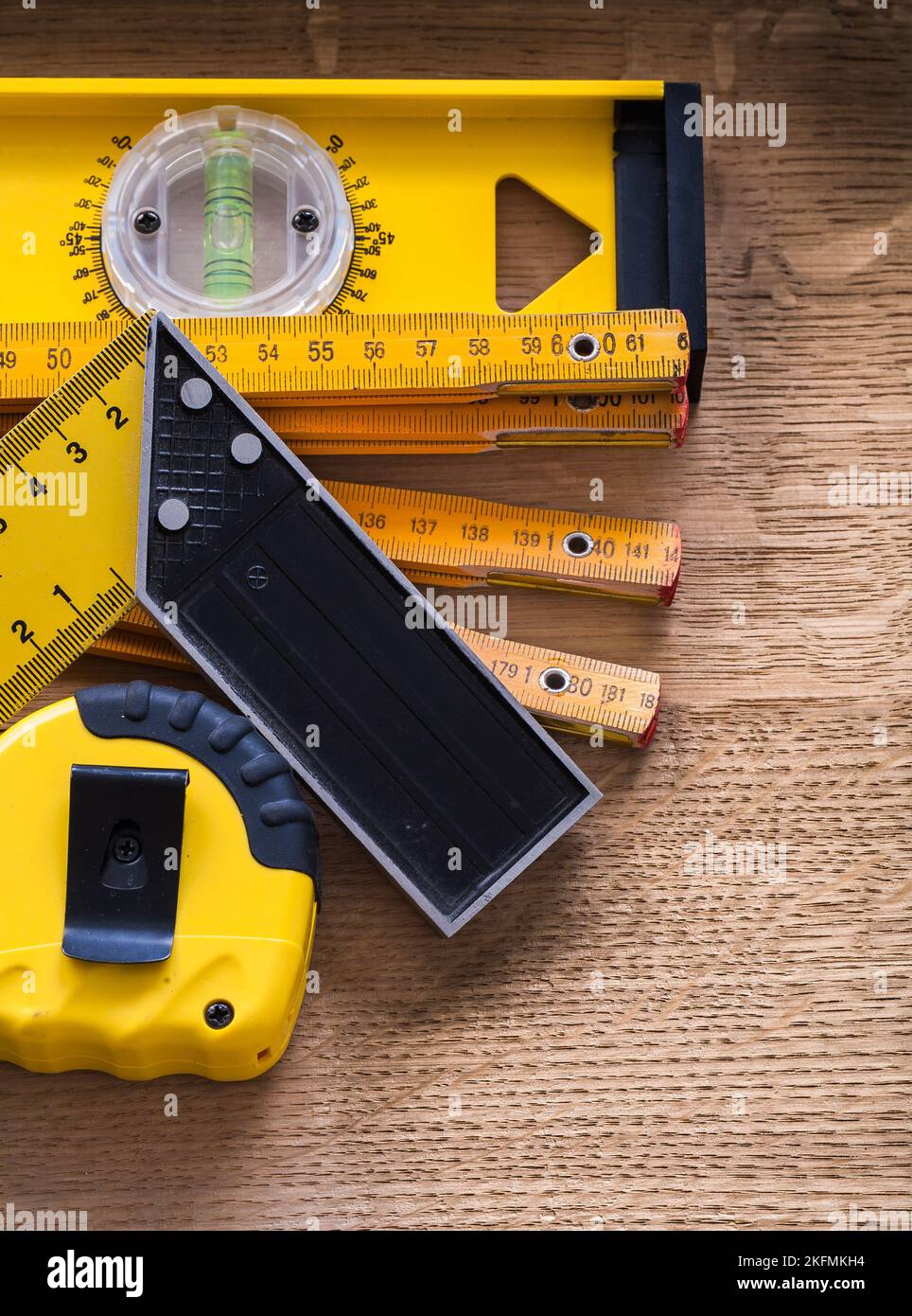 Wooden board with measuring line meter construction level and square ...