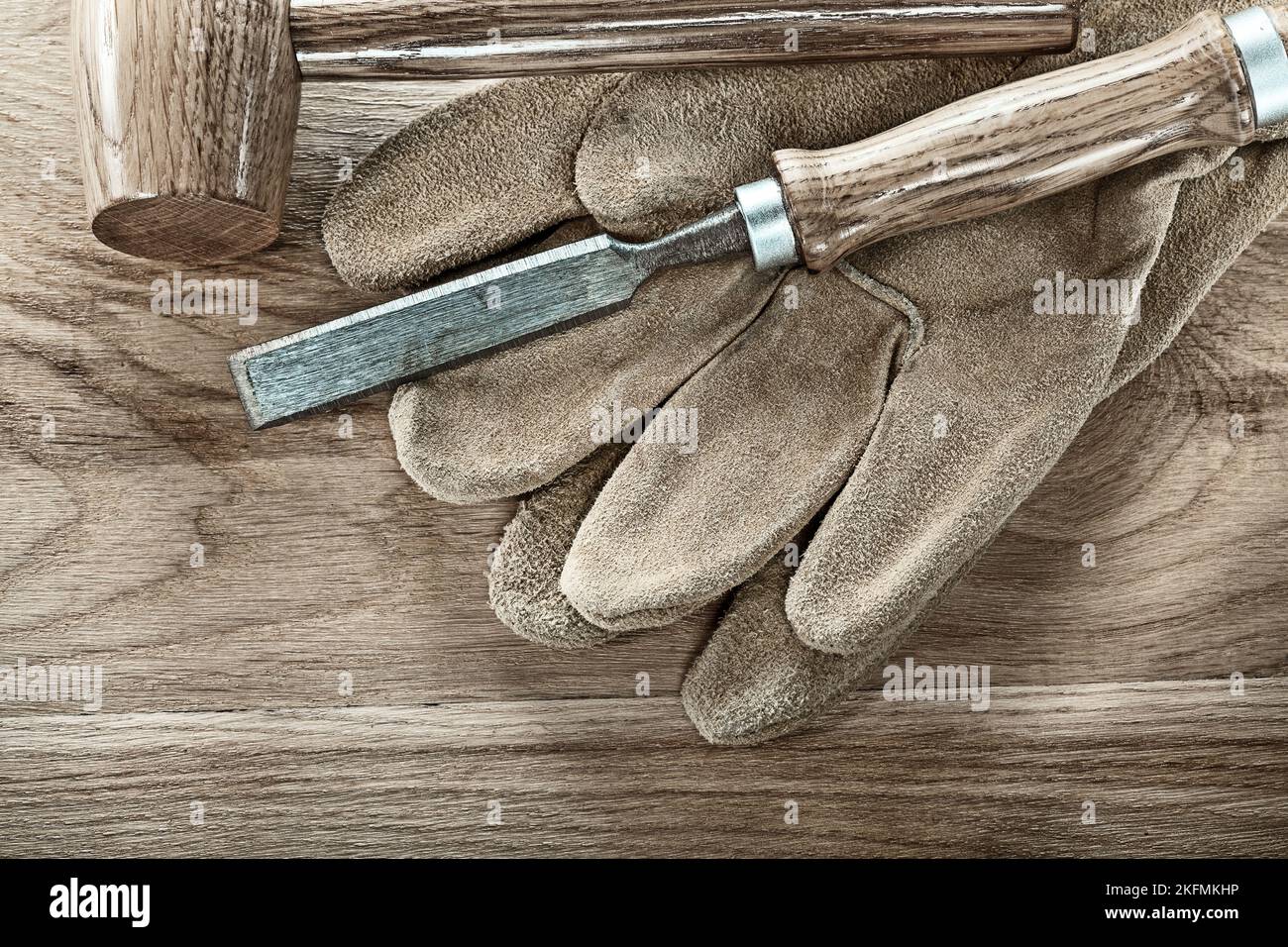 Wooden hammer chisel safety gloves on wood board Stock Photo - Alamy