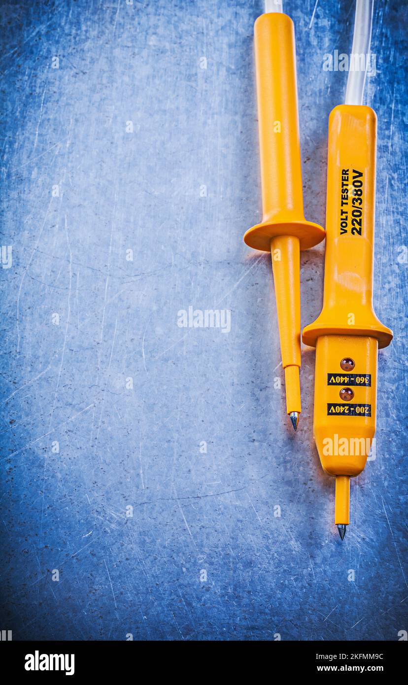 Yellow electrical tester on scratched metallic background Stock Photo ...