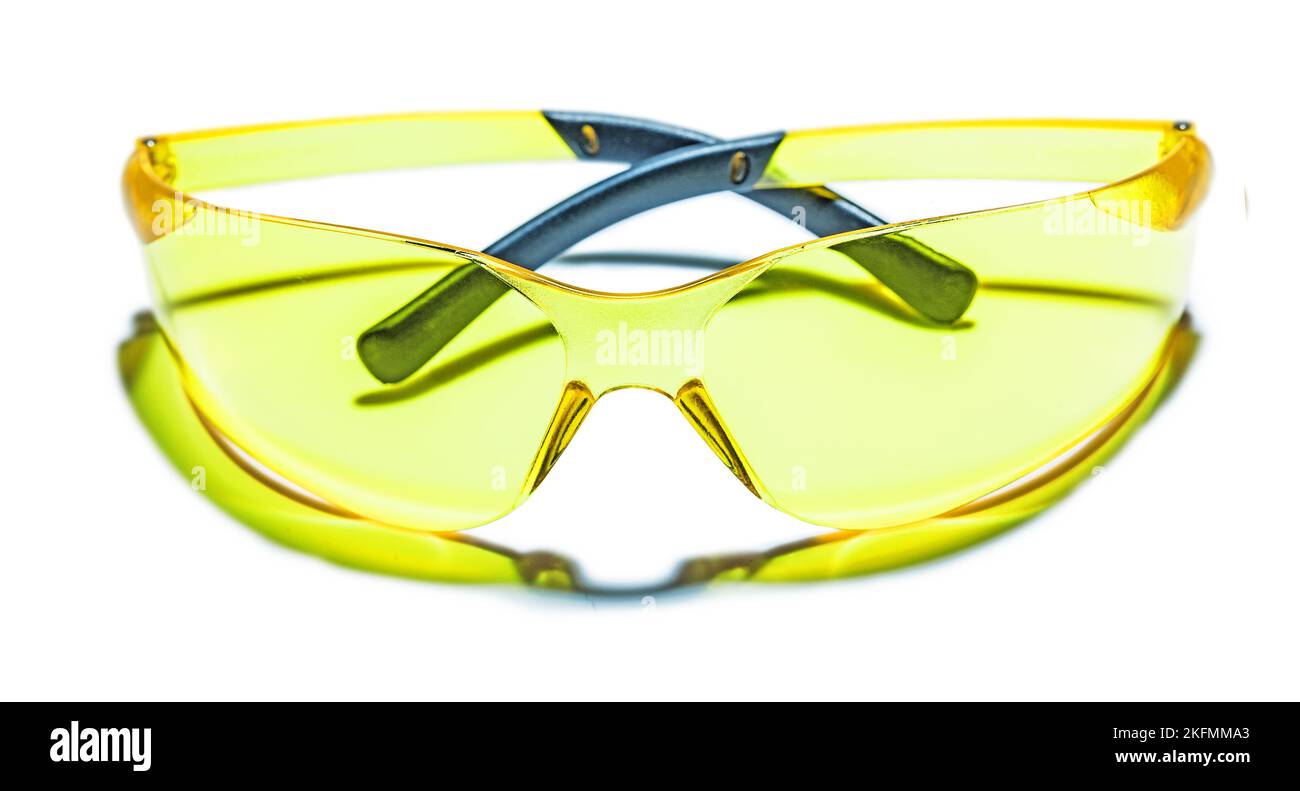 yellow colored working goggles isolated on white Stock Photo - Alamy