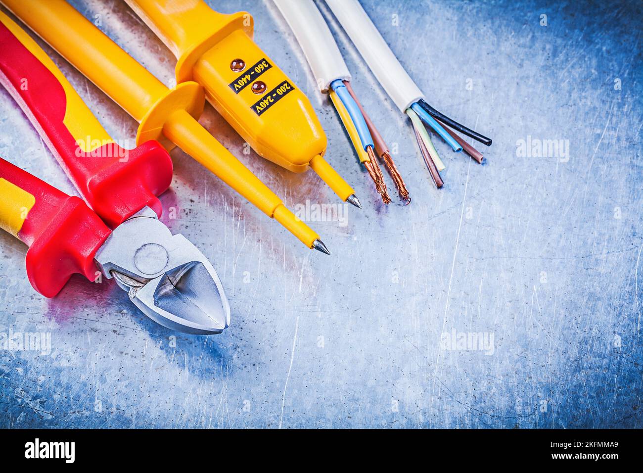 Yellow electrical tester wires wire cutter on metallic background ...