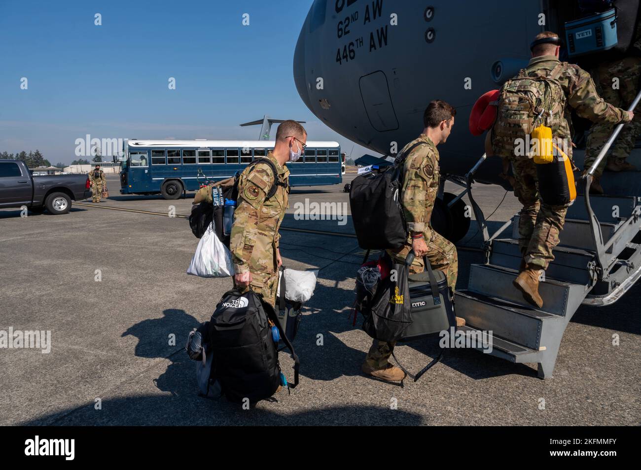 U.S. Air Force Airmen with the 62d Airlift Wing step onto a C-17 ...
