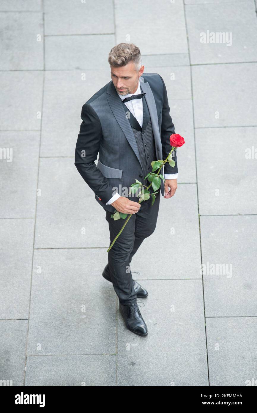 engagement date. tuxedo man celebrates engagement. man with rose gift ...
