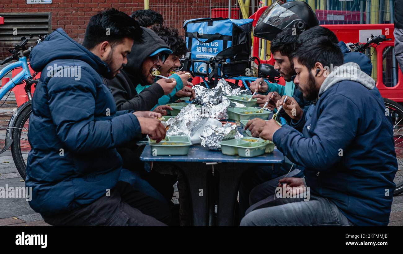 Food delivery workers take time out to feed themselves Stock Photo - Alamy