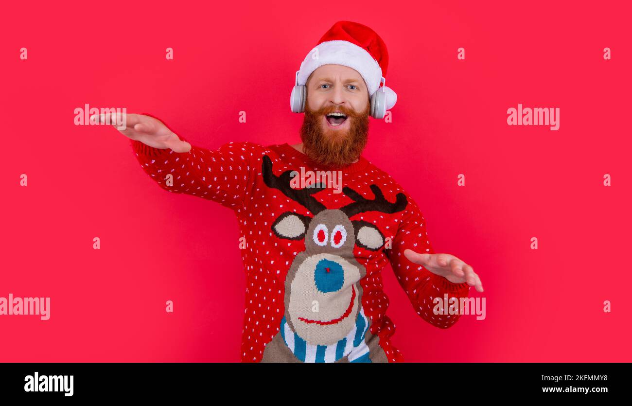 Bearded man celebrating Christmas listening to music. Happy Santa Claus ...