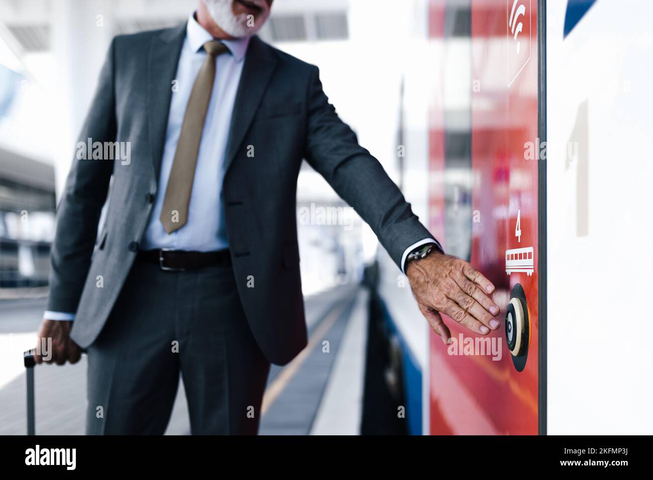 Midsection of businessman pushing open door button of subway train ...
