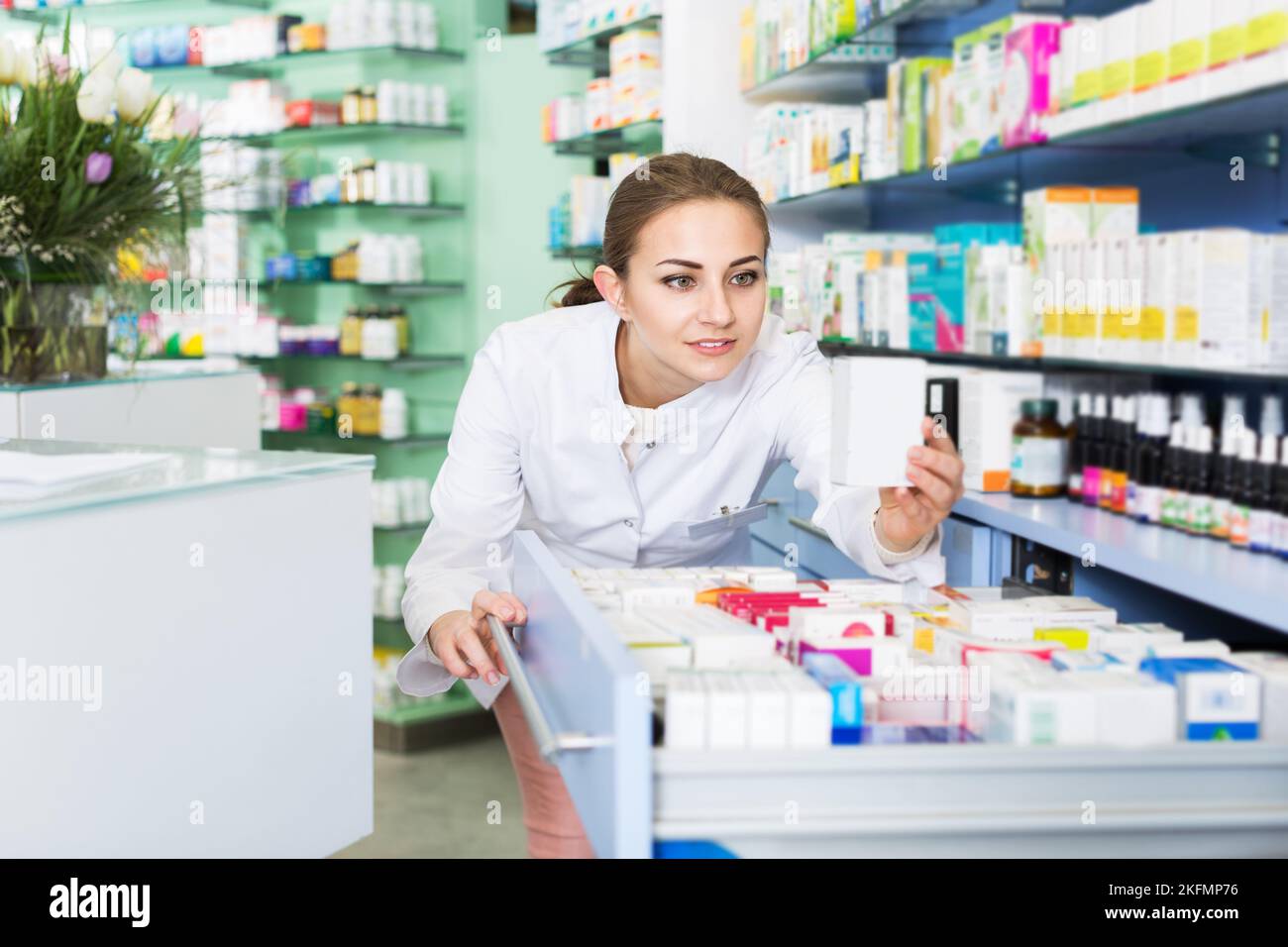 Pharmacist looking medicines in lockers Stock Photo - Alamy