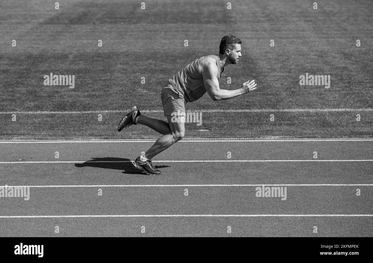 athletic muscular man running in sportswear on stadium track, finish ...