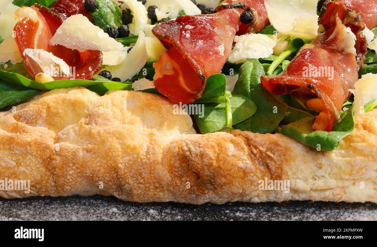 detail of Italian pizza with Grana Cheese Rucola cheese flakes and ...