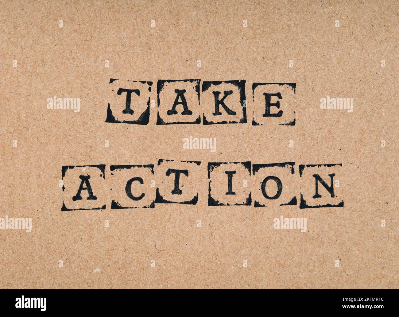 A Cardboard with words Take Action made by black alphabet stamps Stock ...