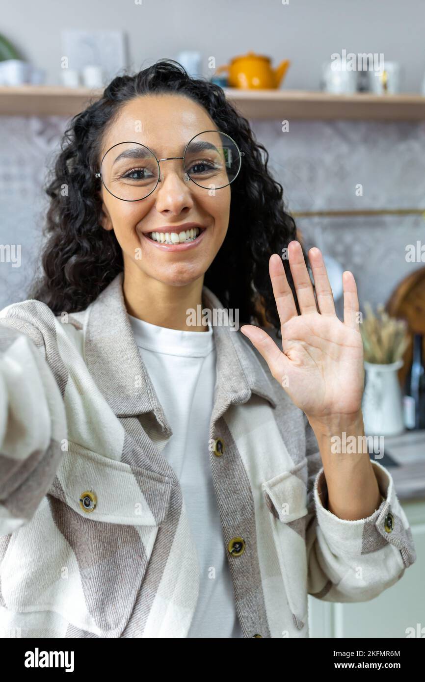 Woman smiles waves hand in hi-res stock photography and images - Alamy
