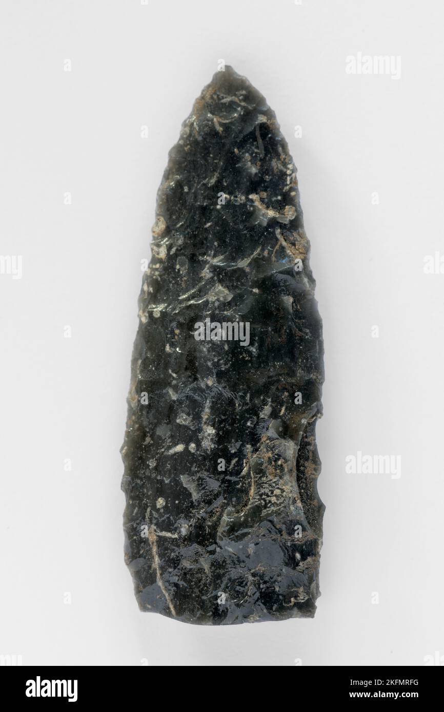 Neolithic obsidian arrowhead on white background Stock Photo - Alamy