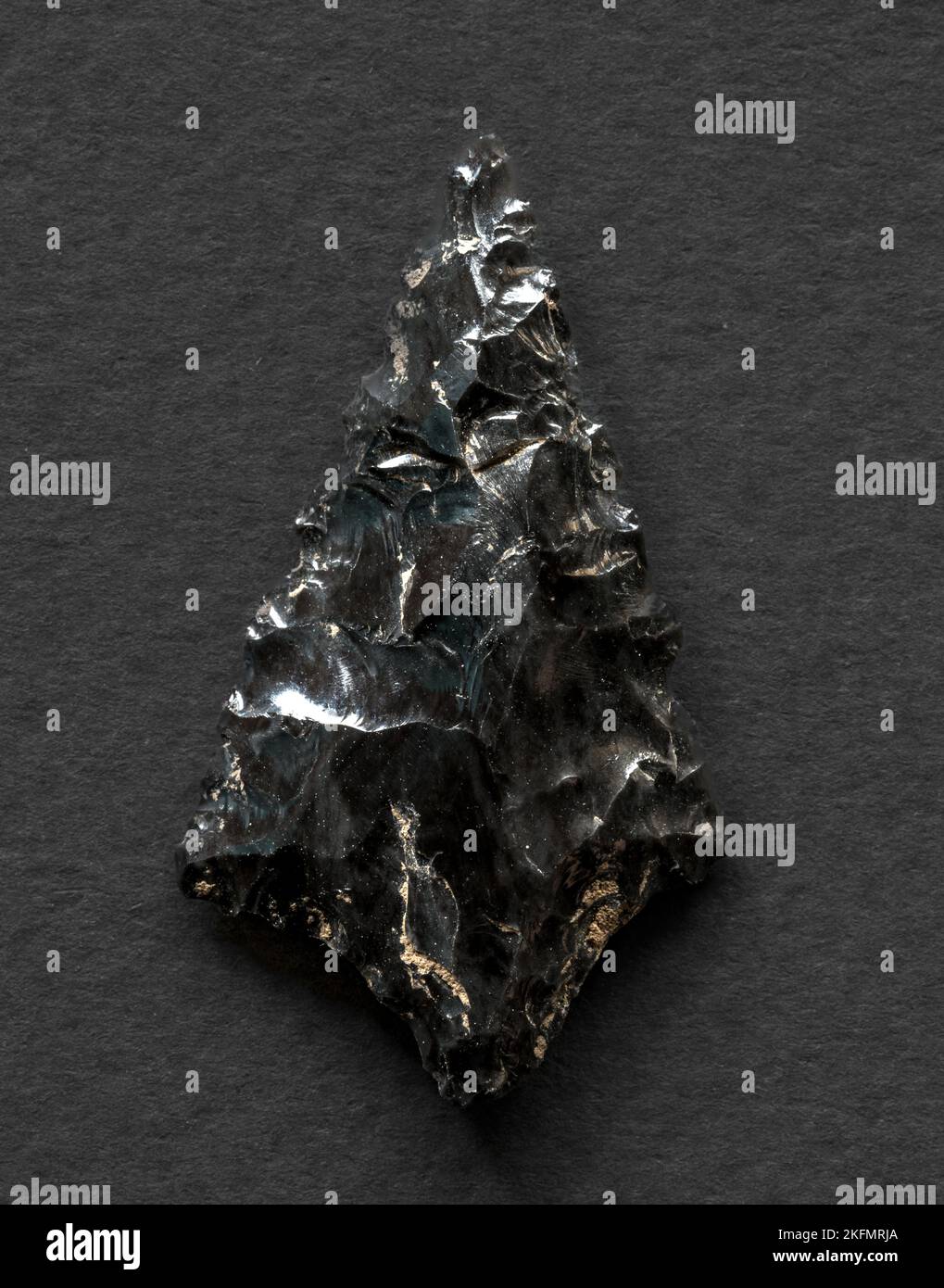 Neolithic obsidian arrowhead on dark background Stock Photo - Alamy