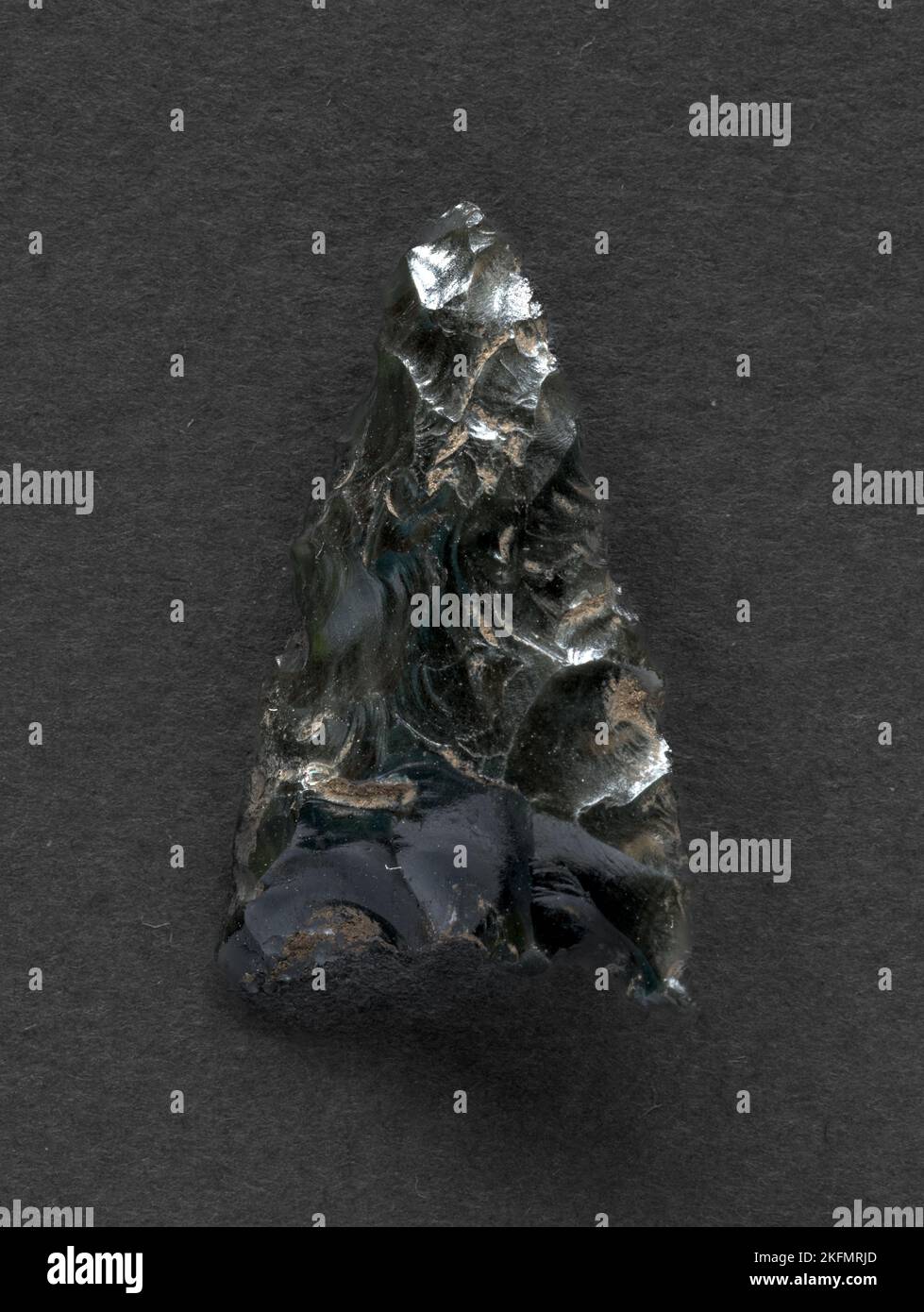Neolithic obsidian arrowhead on dark background Stock Photo - Alamy