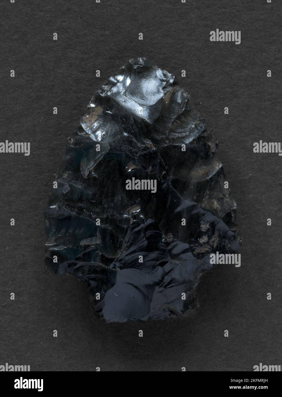 Neolithic obsidian arrowhead on dark background Stock Photo - Alamy