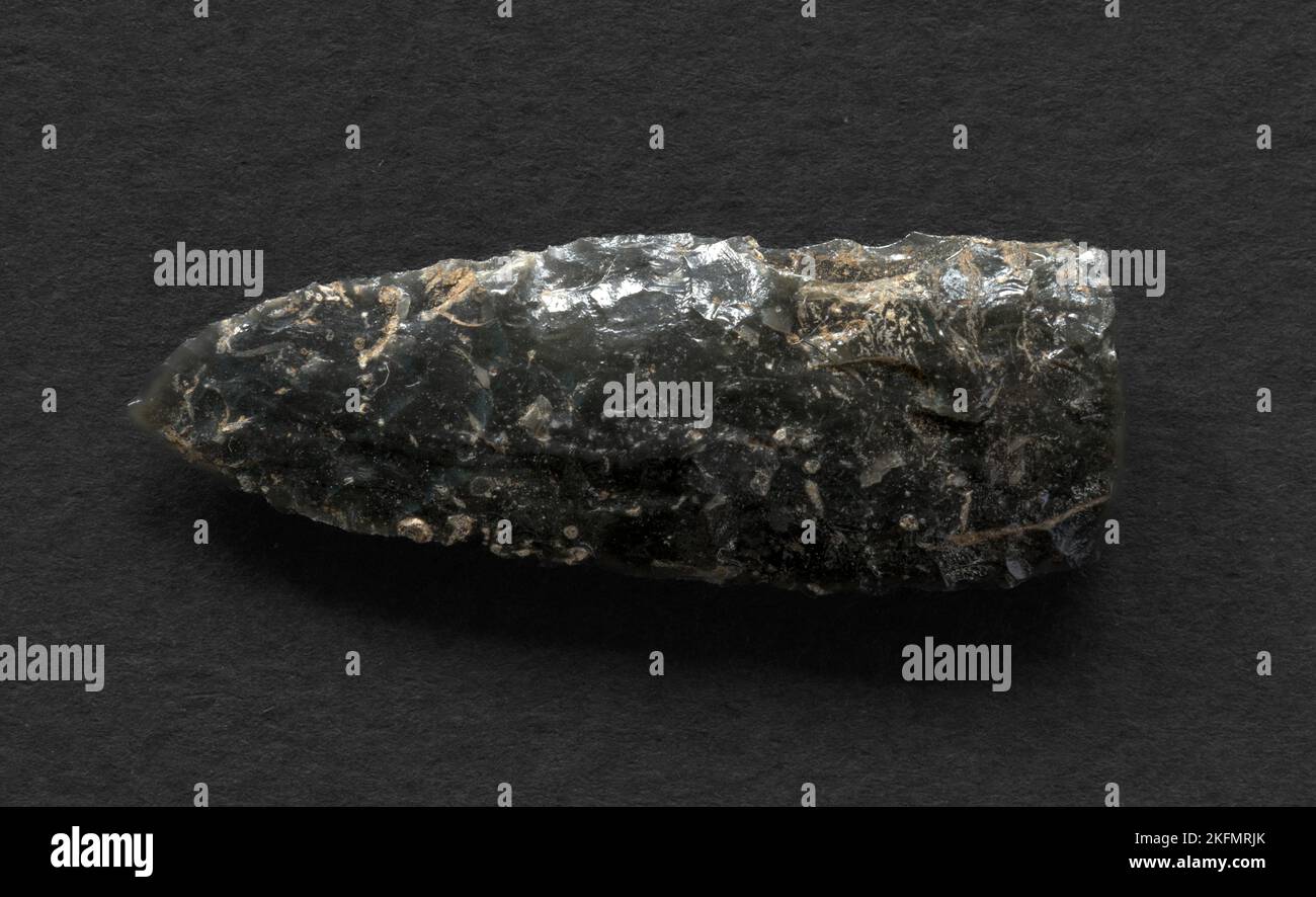 Neolithic obsidian arrowhead on dark background Stock Photo - Alamy