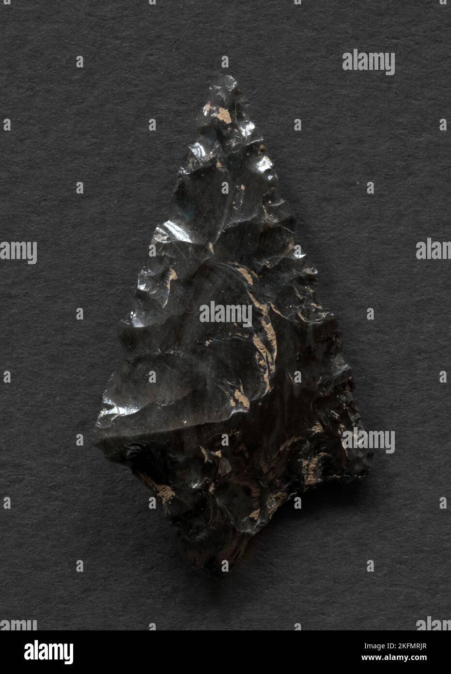 Neolithic obsidian arrowhead on dark background Stock Photo - Alamy