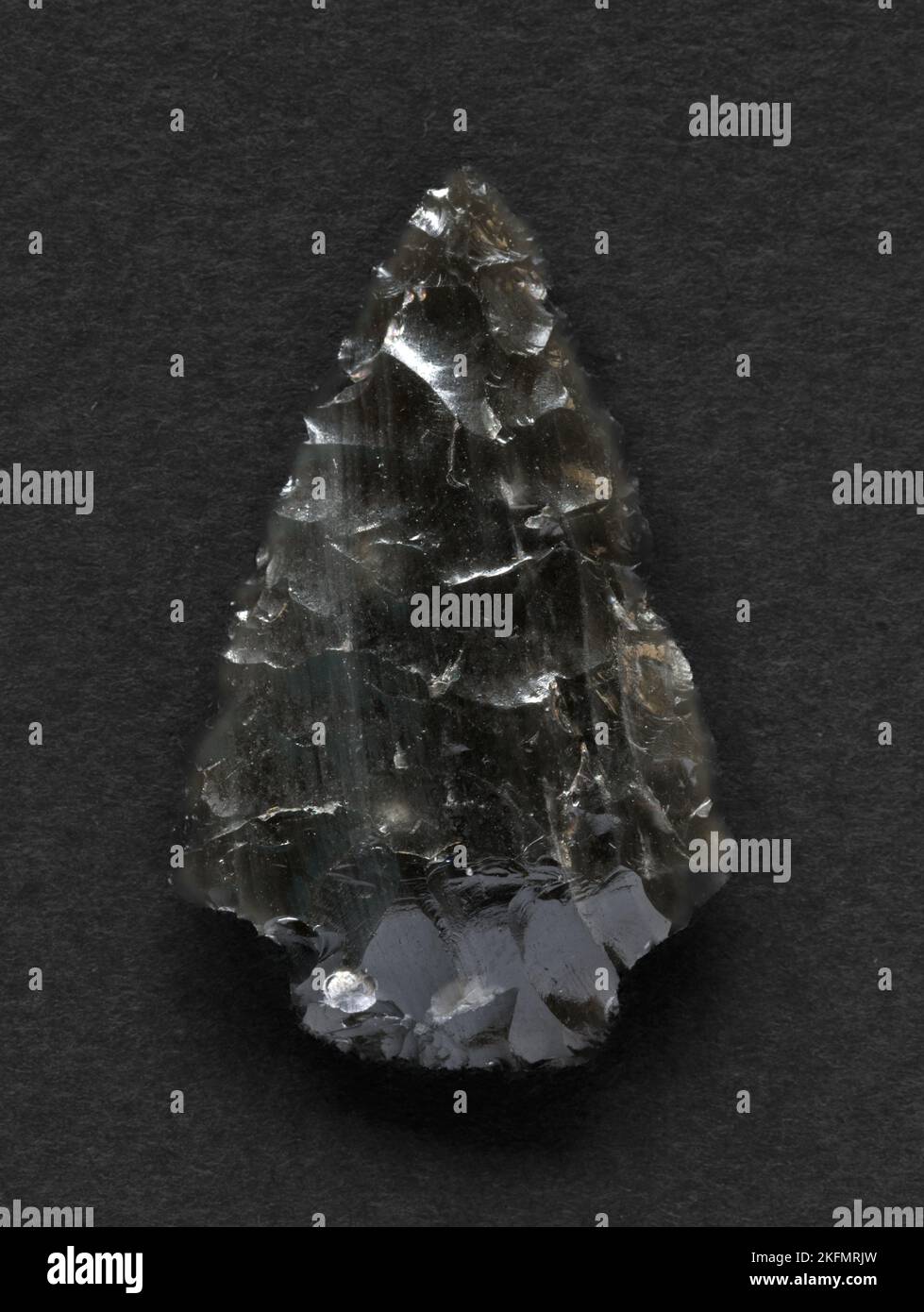 Neolithic obsidian arrowhead on dark background Stock Photo - Alamy