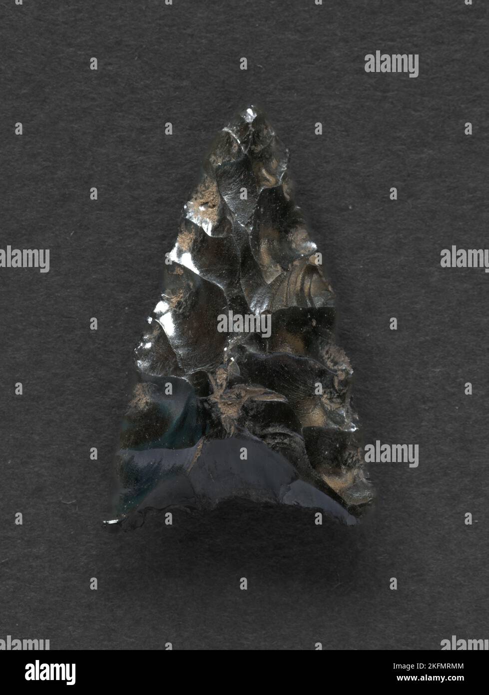 Neolithic obsidian arrowhead on dark background Stock Photo - Alamy