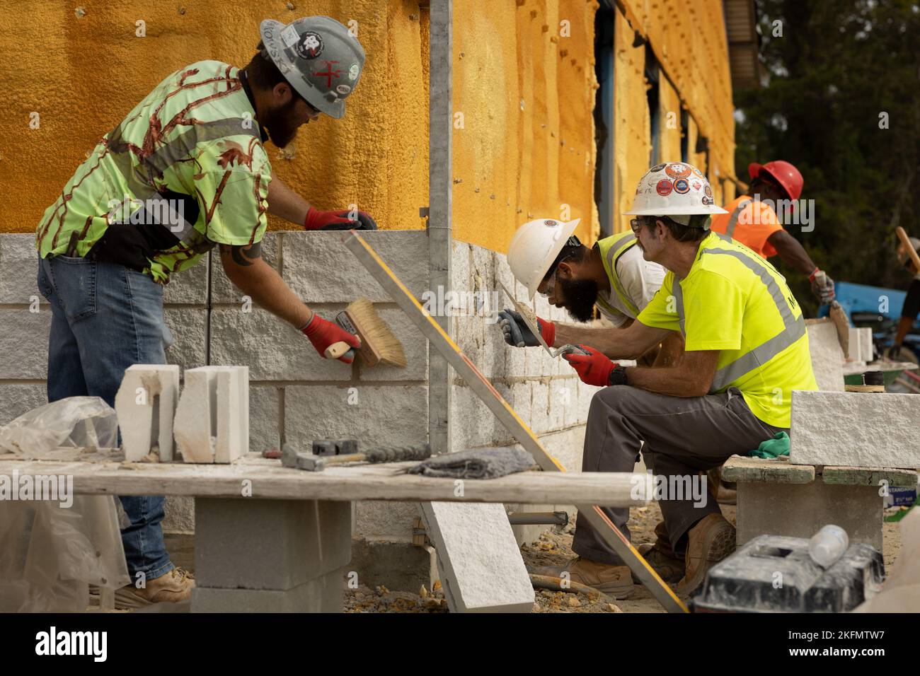 Masons with Rush Masonry Management LLC, conduct masonry work at the ...