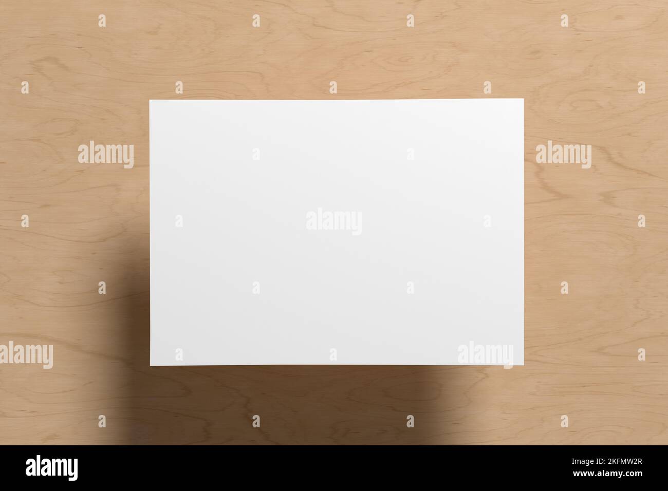 A sheet of paper mock up floating above the wooden table table Stock ...