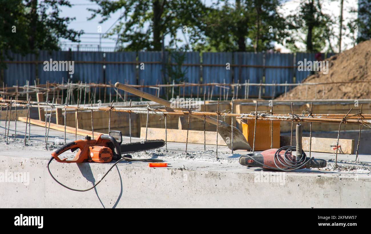 Electric tool concrete foundation of a huge fenced construction site in ...
