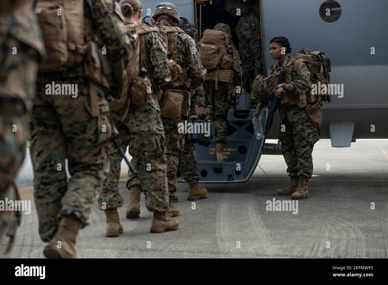 U.S. Marines with 3d Marine Division board a KC-130J Super Hercules ...